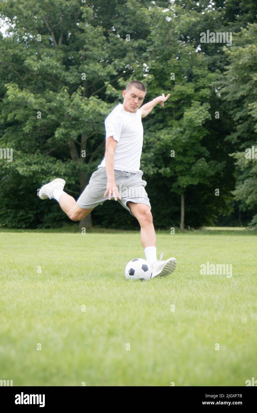 A Nineteen Year Old Teenage Boy Playing Football in A Public Park Stock Photo - Alamy