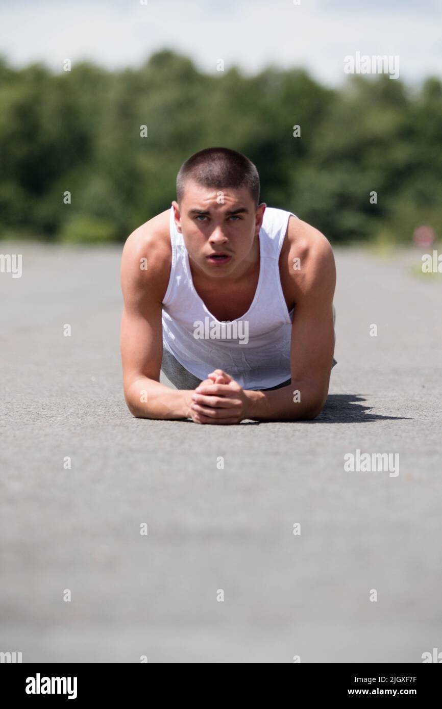 A Nineteen Year Old Teenage Boy Doing The Plank In A Public Park Stock ...