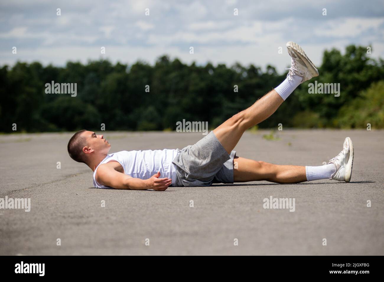 A Nineteen Year Old Teenage Boy Doing Leg Raises In A Public Park Stock ...