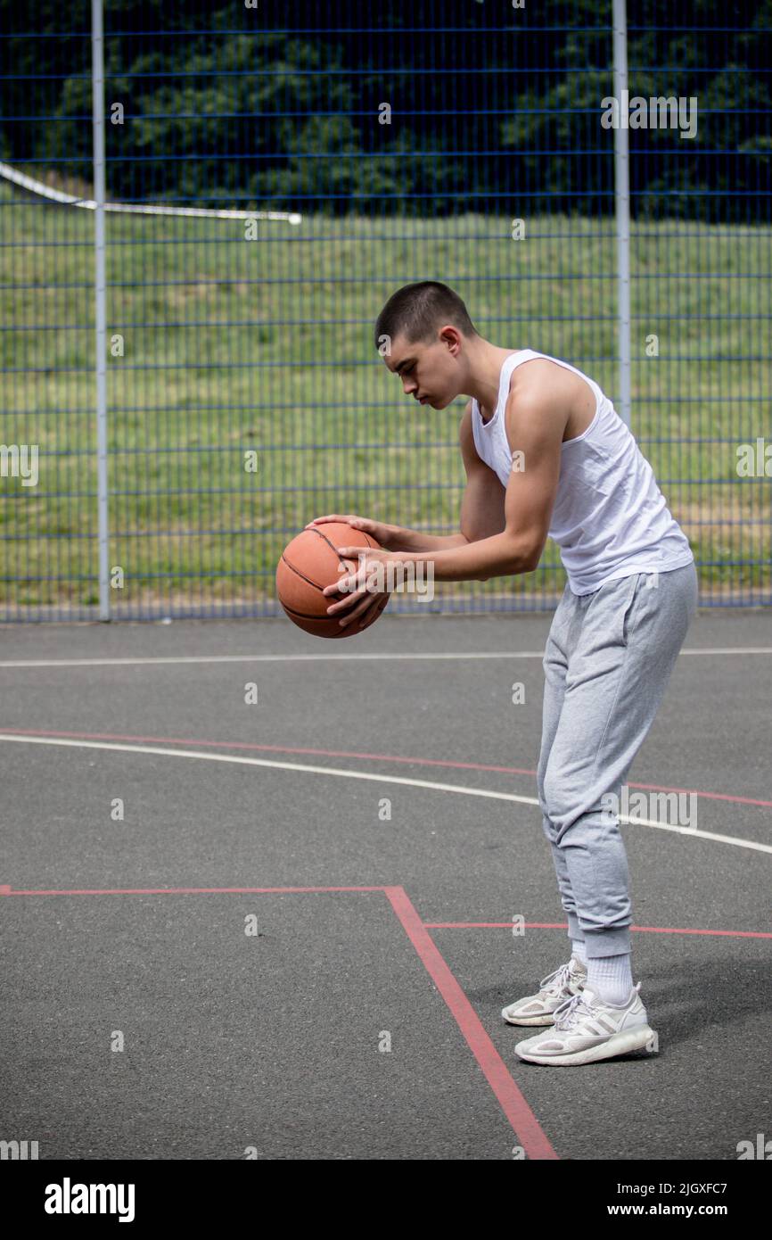 A Nineteen Year Old Teenage Boy Shooting A Hoop in A Basketball Court ...