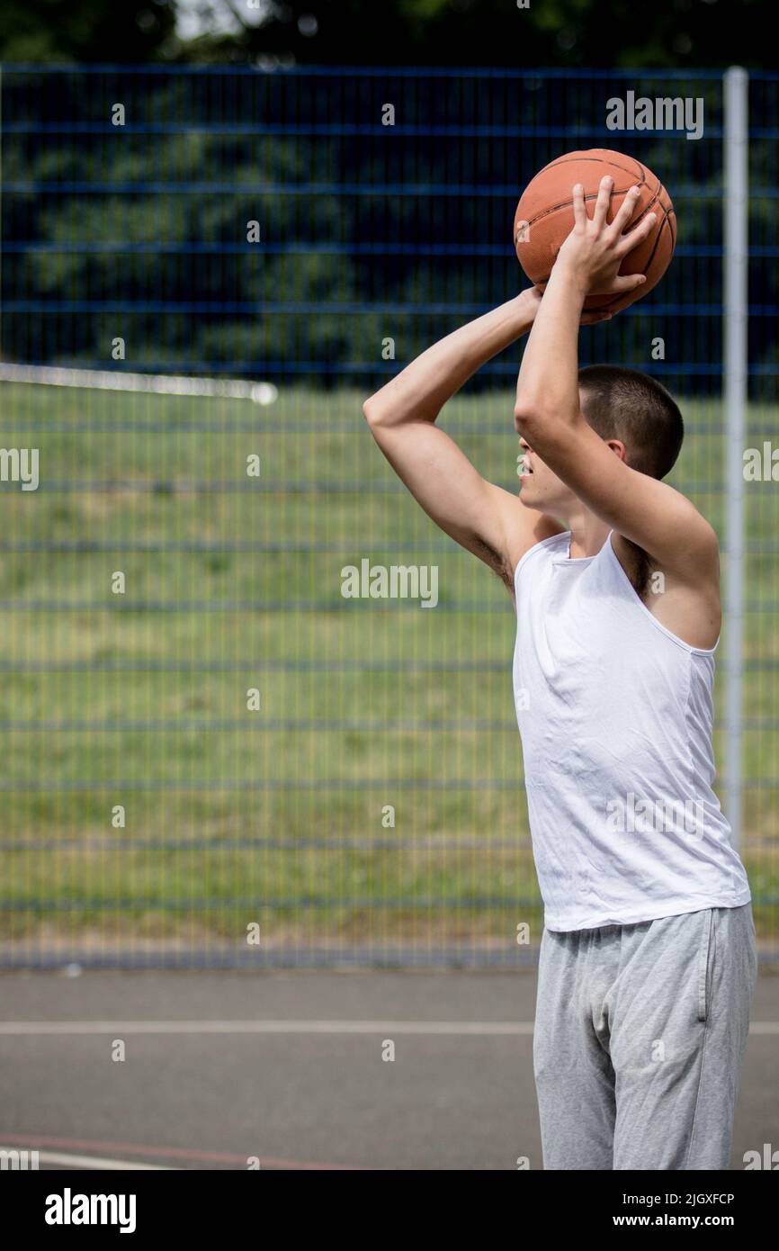 A Nineteen Year Old Teenage Boy Shooting A Hoop in A Basketball Court ...