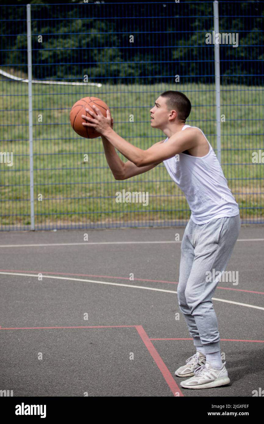 A Nineteen Year Old Teenage Boy Shooting A Hoop in A Basketball Court ...