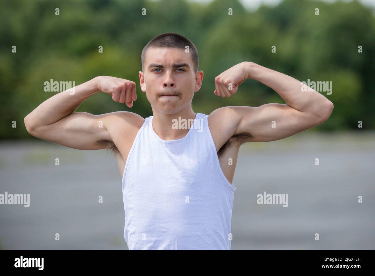 Boy flexing biceps hi-res stock photography and images - Alamy