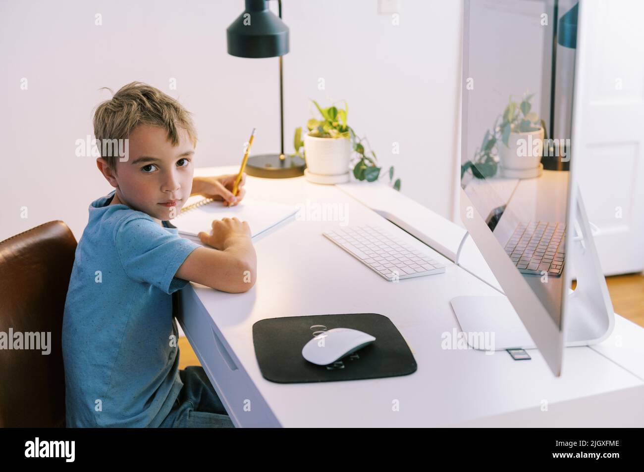Boy doing homework with color pencil hi-res stock photography and ...