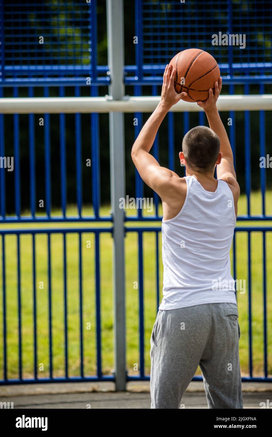 A Nineteen Year Old Teenage Boy Shooting A Hoop in A Basketball Court ...