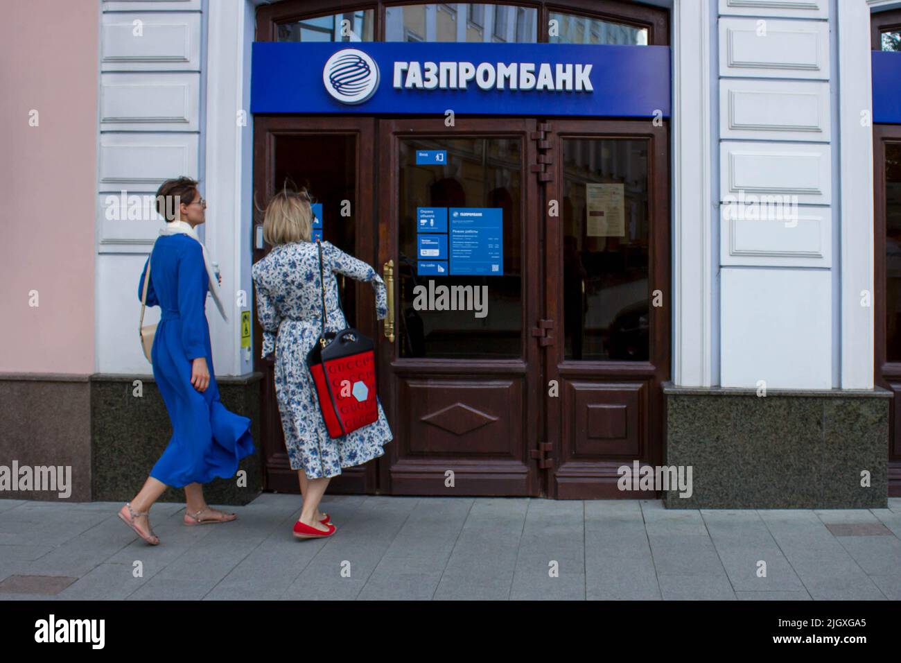 Moscow, Russia. 11th July, 2022. Women walk into a Gazprom bank office ...