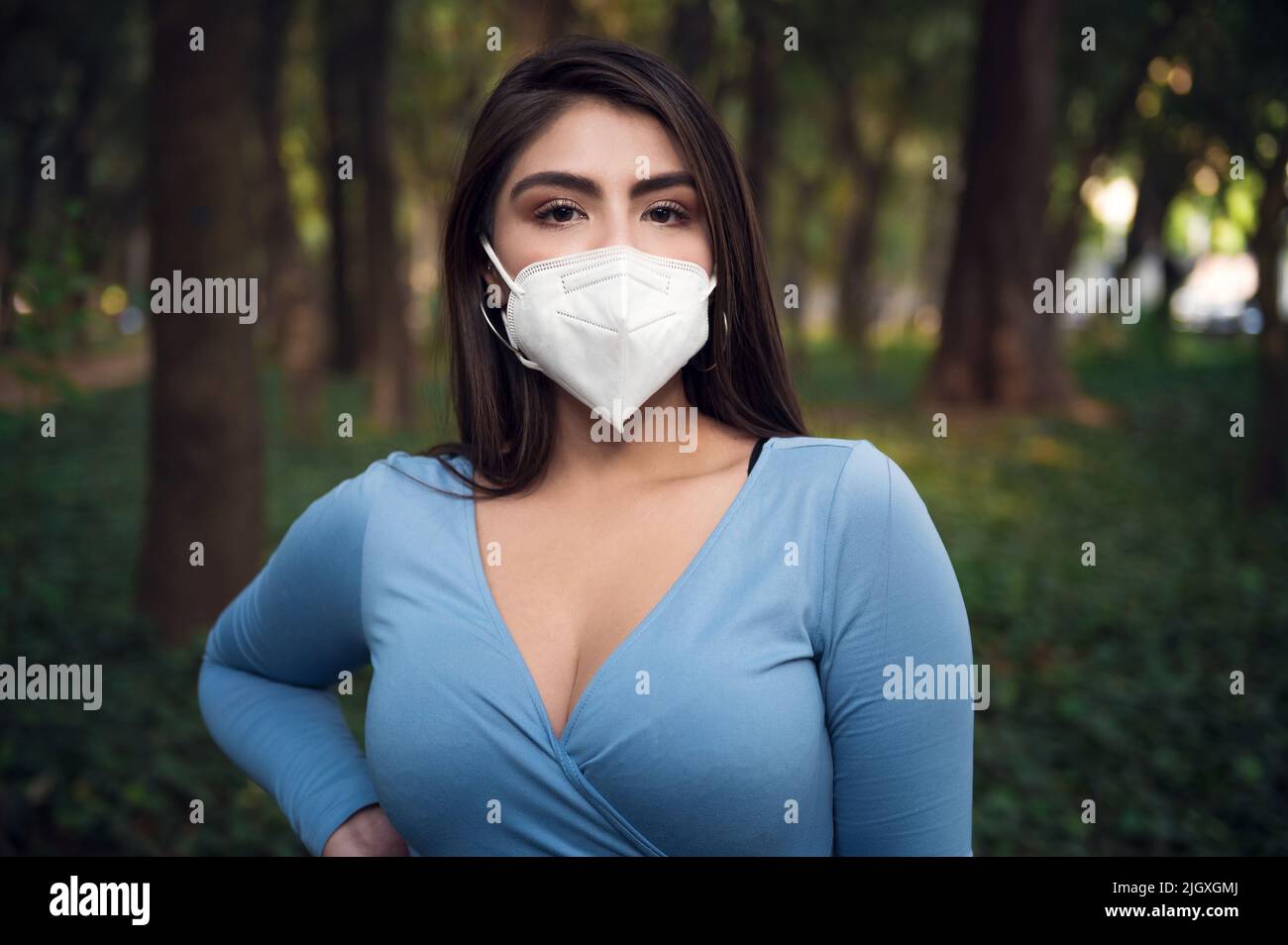 Young latin female in the park with face mask Stock Photo - Alamy