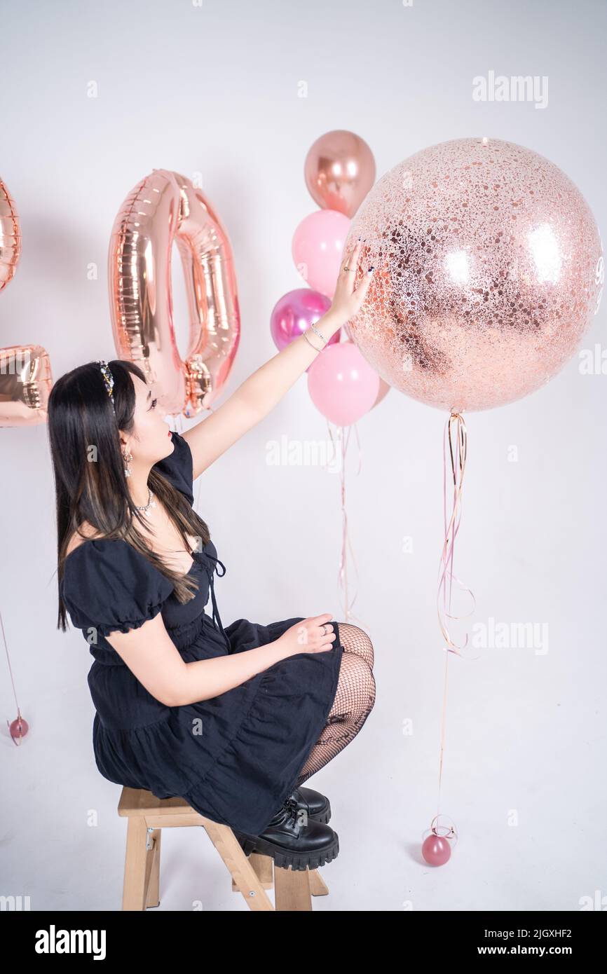 cute young asian woman touches a transparent ball with confetti Stock ...