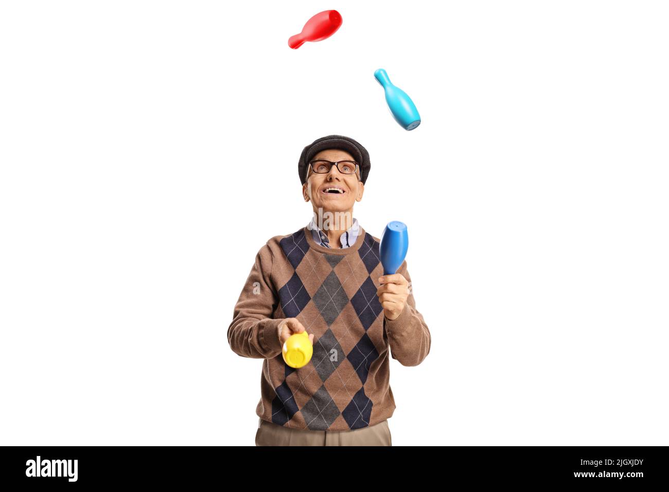 Elderly man juggling with clubs isolated on white background Stock ...