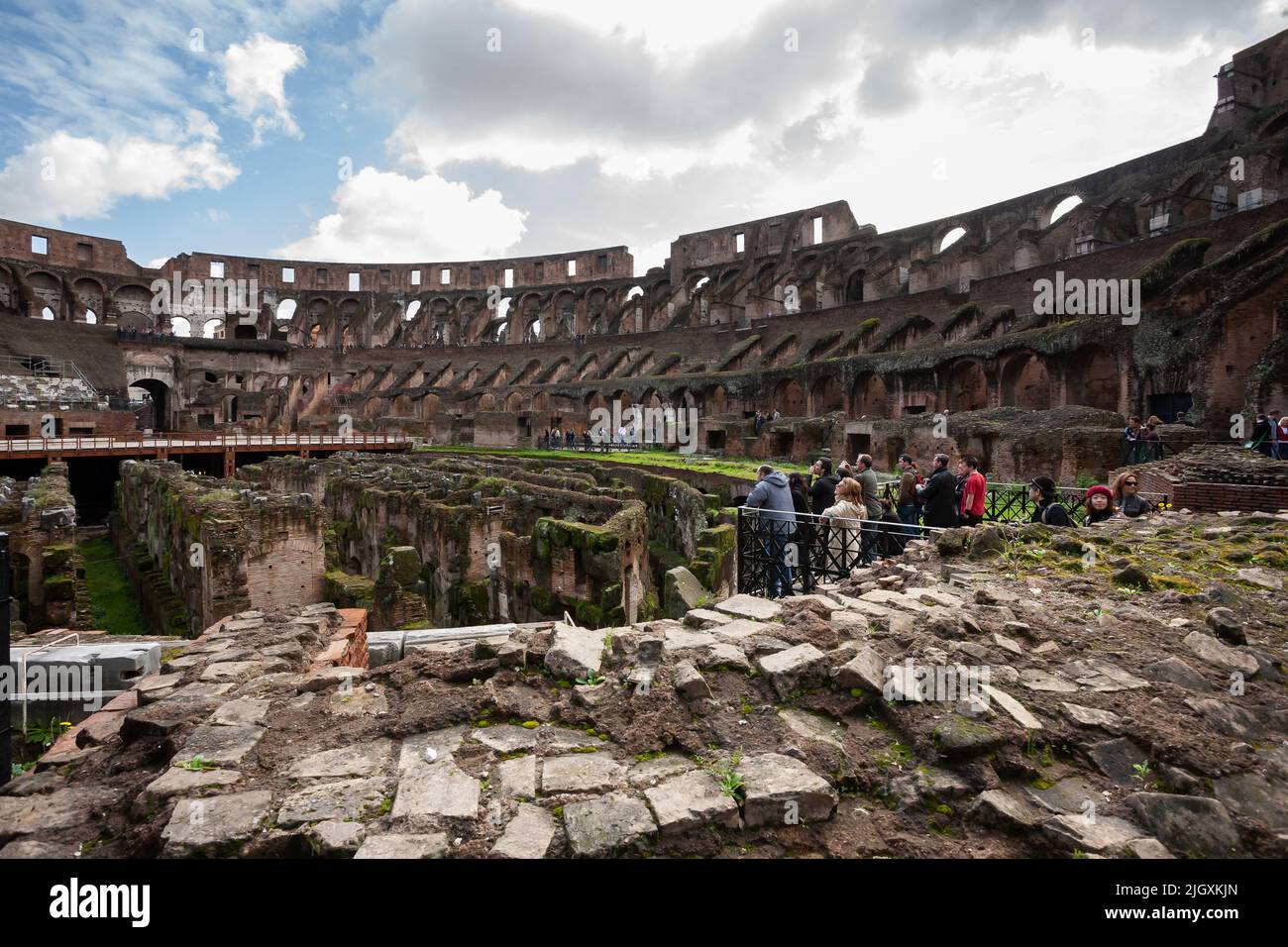Tourists walking among the ruins of the Roman Colosseum, Rome, Italy ...