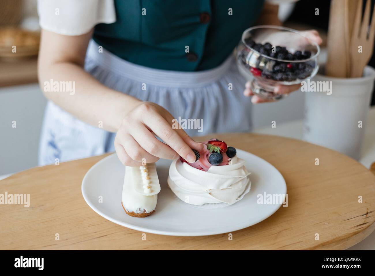Girl decorating cake kitchen hi-res stock photography and images - Alamy