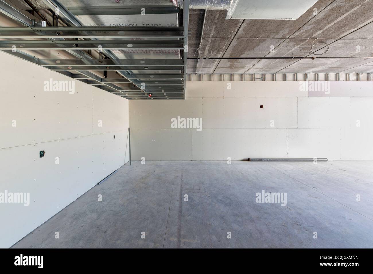 Large room (classroom) under construction with drywall partially ...