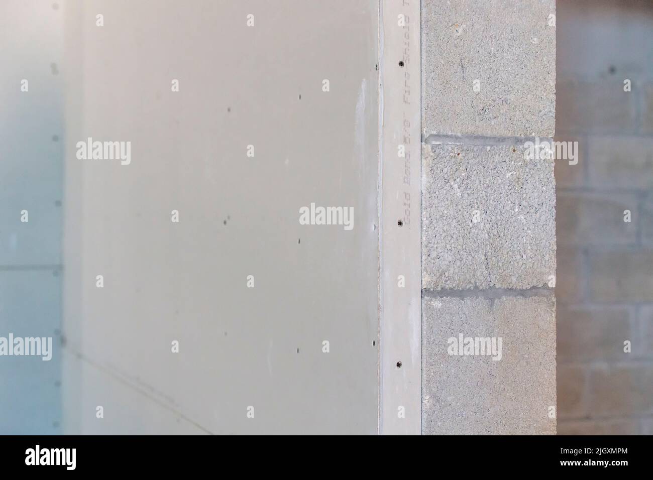 Drywall panels, partially installed on galvanized steel framing struts ...