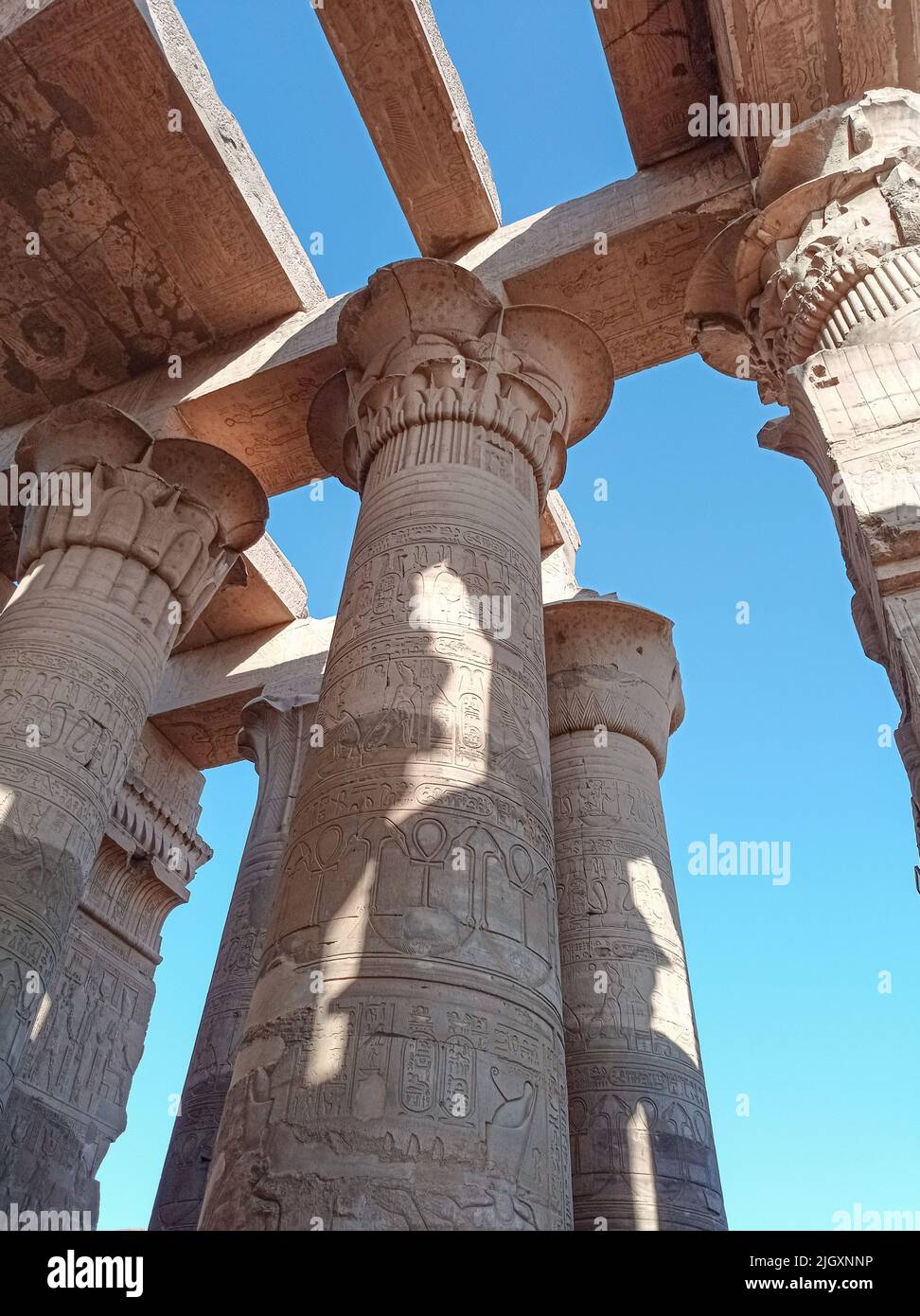 Ruins of an ancient egyptian temple with columns full of hieroglyphs in ...