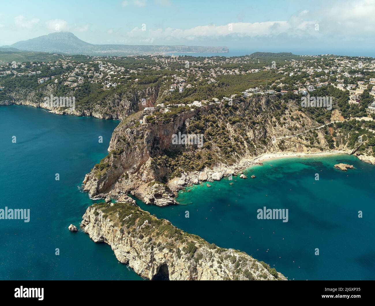 A cliff near the seashore overseeing the deep ocean and city Stock ...