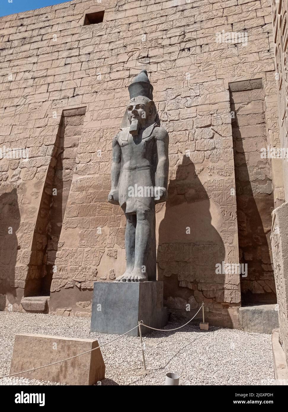 Detail of an ancient statue of an old pharaoh on a ruined temple in ...