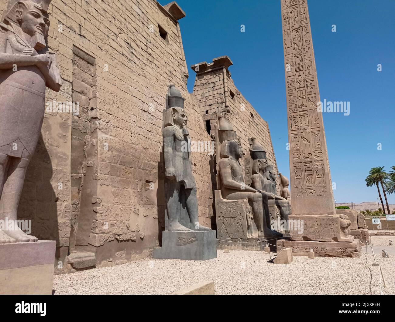 Ancient egyptian temple with an obelisk full of hieroglyphics and ...