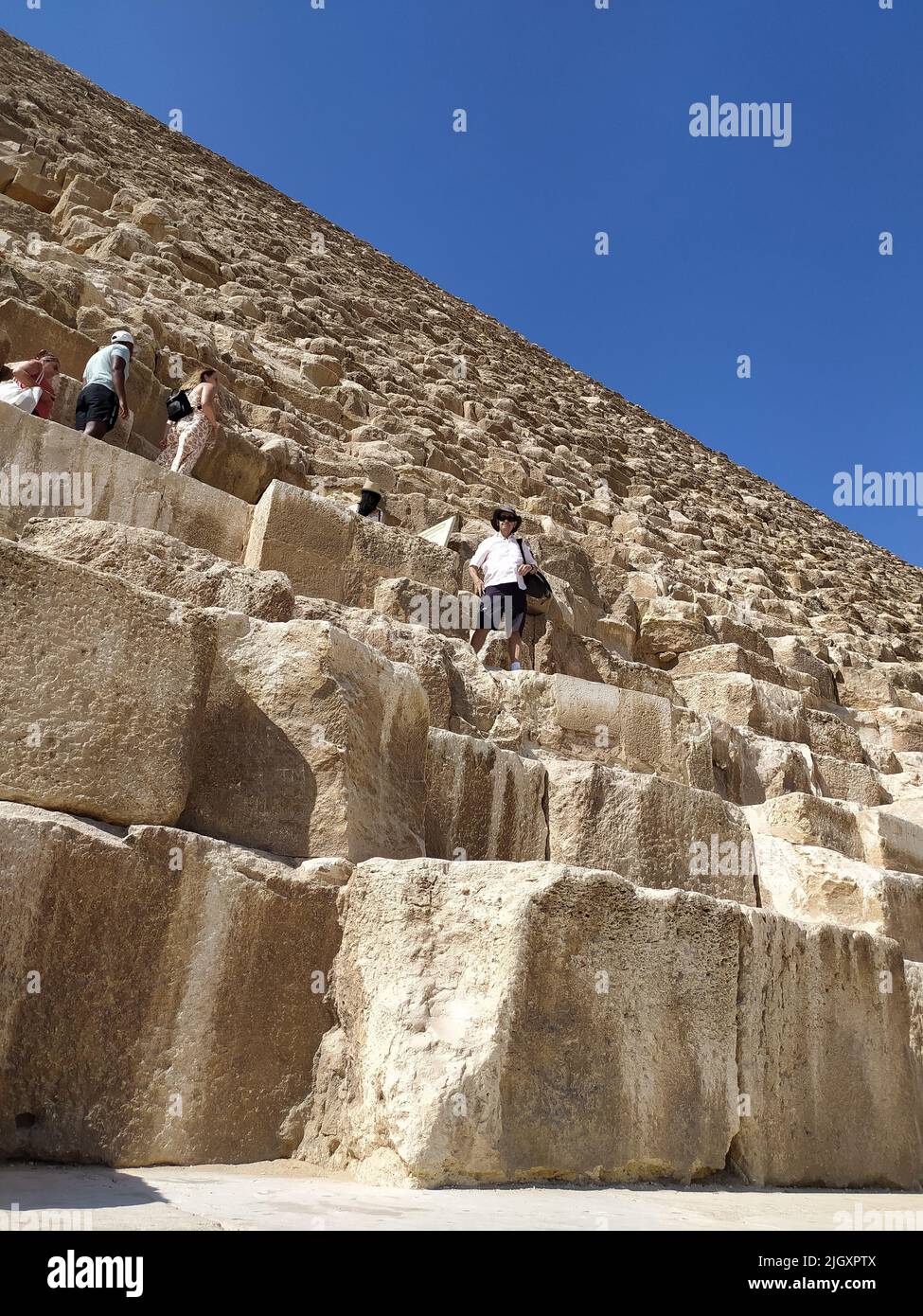 Tourists climbing on the great pyramid of Giza in Egypt, Africa Stock ...