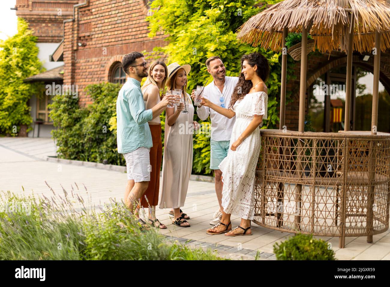 Group of happy young people cheering and having fun outdoors with ...