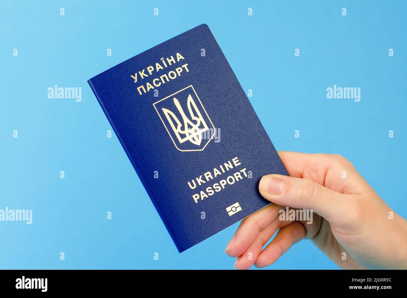 Passport of a citizen of Ukraine in a female hand close-up. Inscription ...