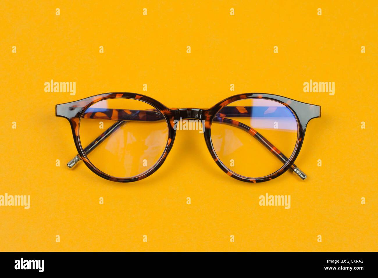 Stylish leopard-colored eyeglasses on an orange background Stock Photo ...