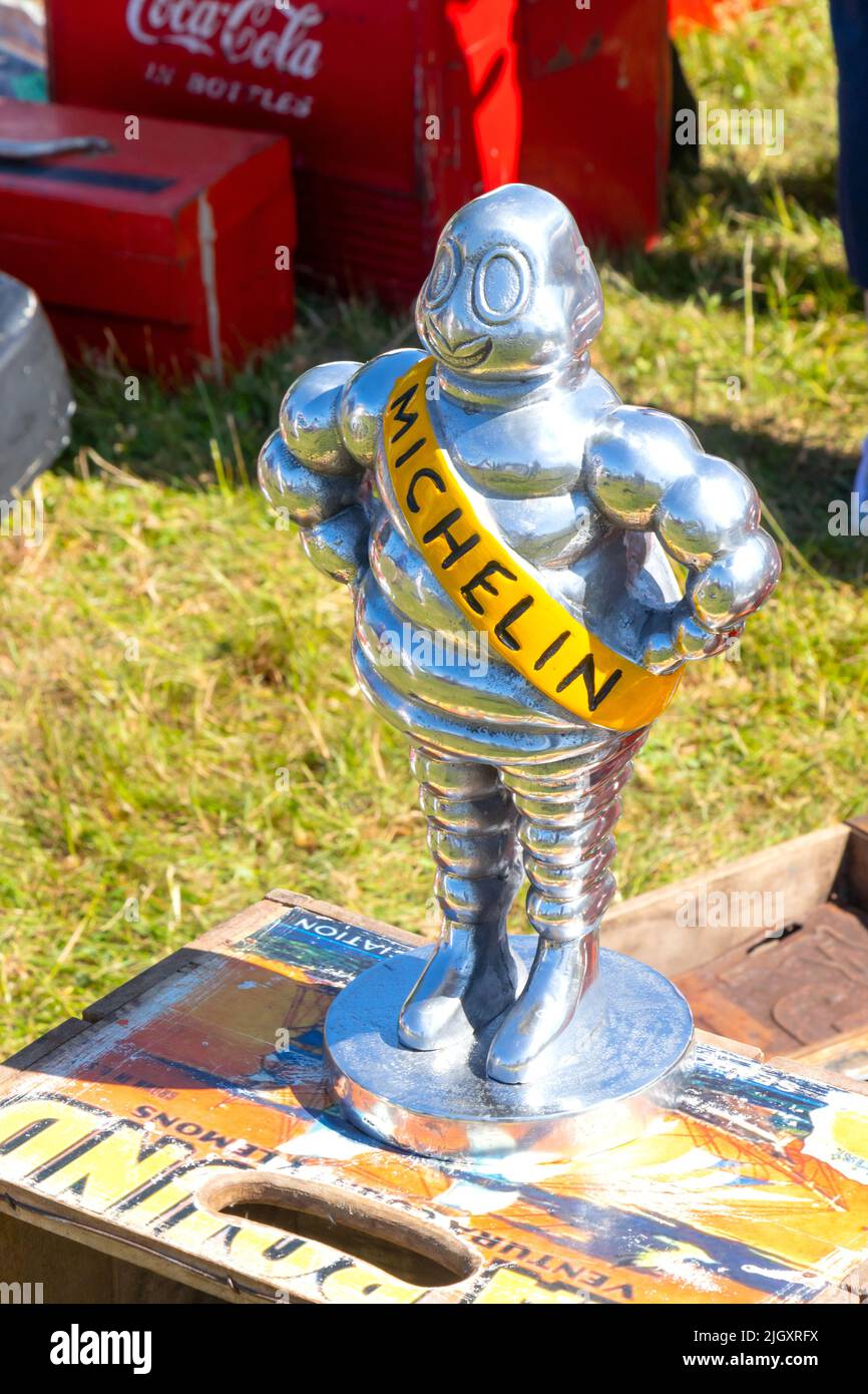 chrome michelin man bibendum statue with yellow michelin sash at car ...