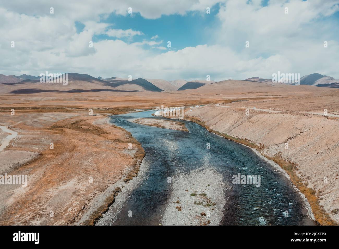 blue river flowing through Deosai National Park in Pakistan on sunny ...