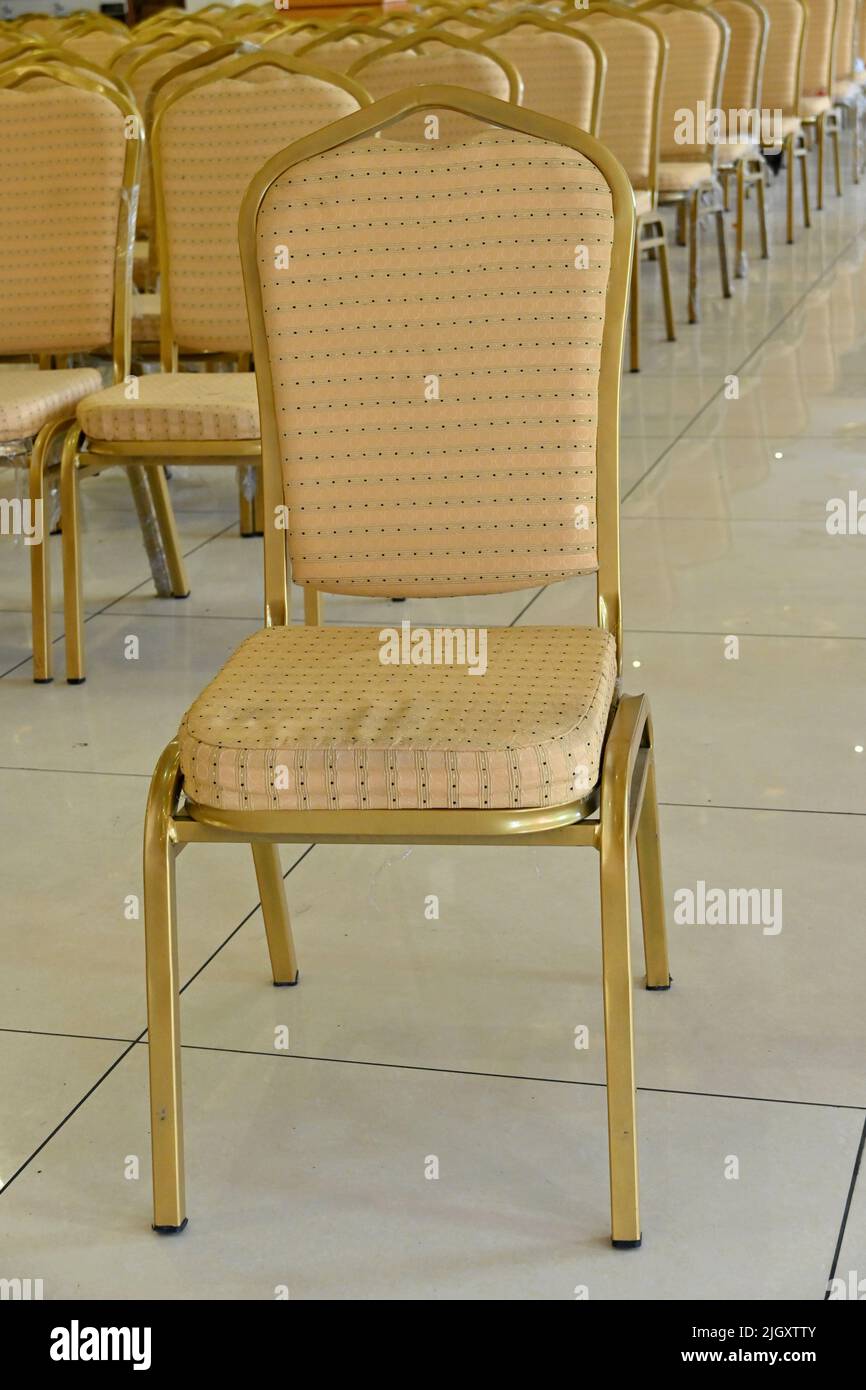 closeup the yellow golden metal chairs in the row soft focus natural ...