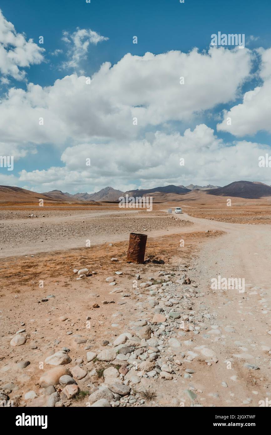 one single empty trash can in the middle of a desolate dry desert in ...
