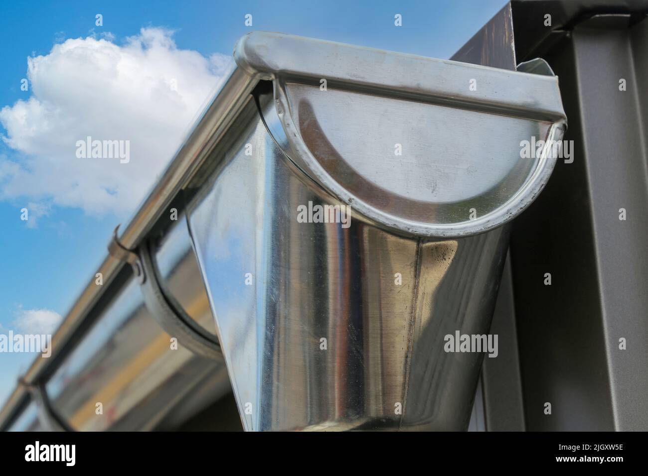 Roof gutter on a new tiled roof Stock Photo - Alamy
