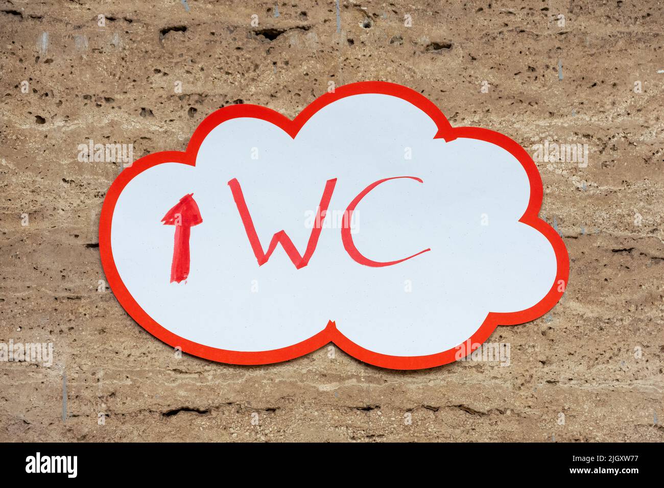 A wc sign from a red cloud with an arrow Stock Photo - Alamy