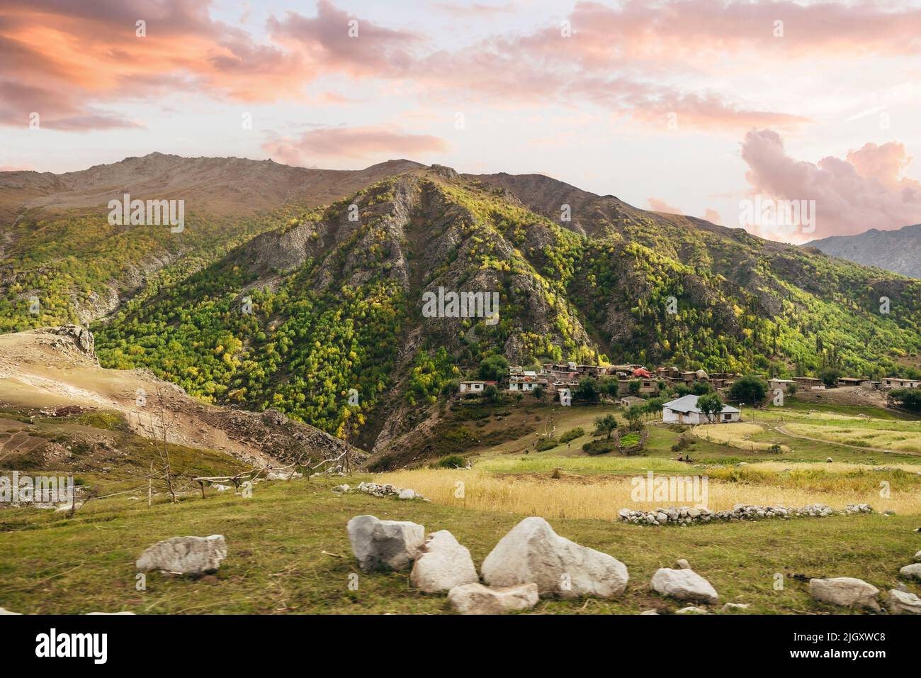 wide nature landscape of Pakistani village homes on a hill in mountains ...