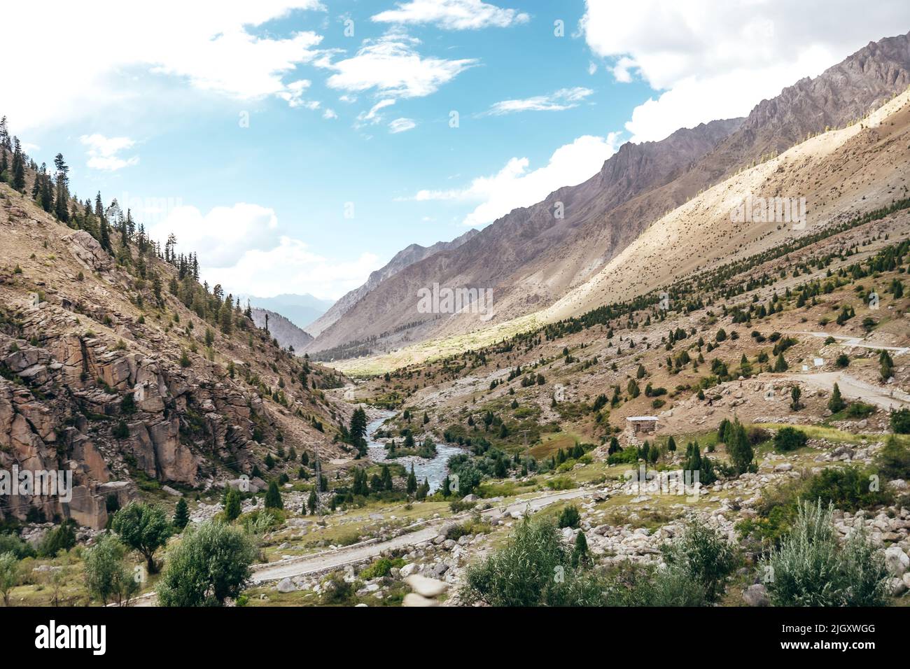 wide landscape of a river flowing through the mountains of Astore ...