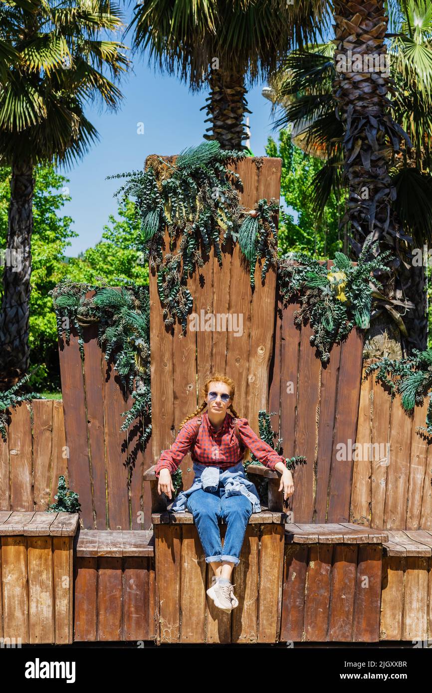 Female sits in a palm tree hi-res stock photography and images - Alamy