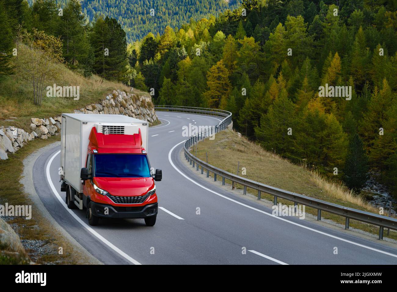 Urban delivery refrigerator box truck with red cabin driving on a ...