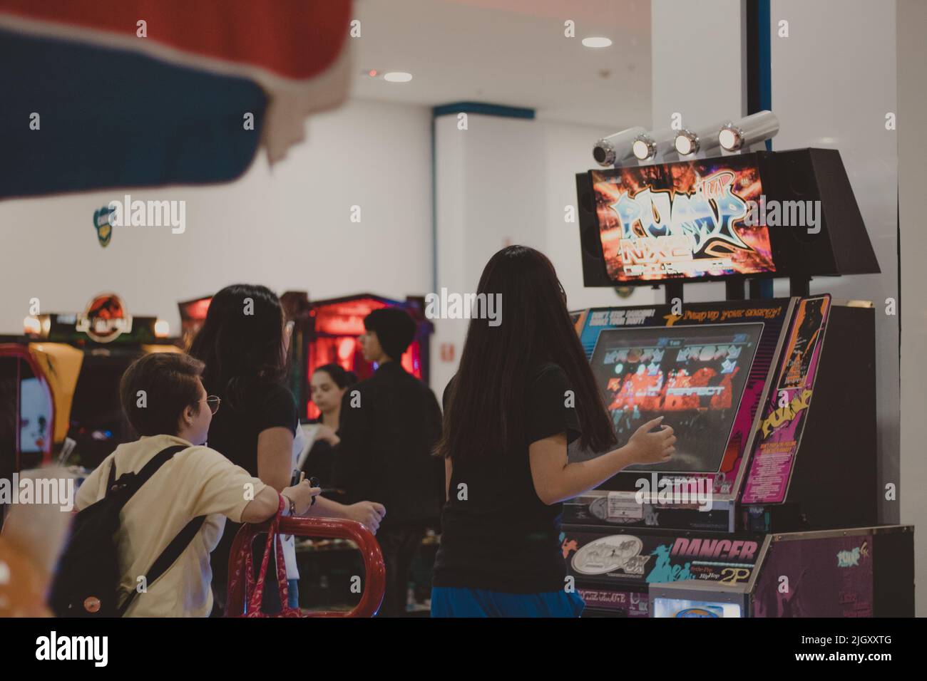 girls dancing on the pump it up machine Stock Photo - Alamy