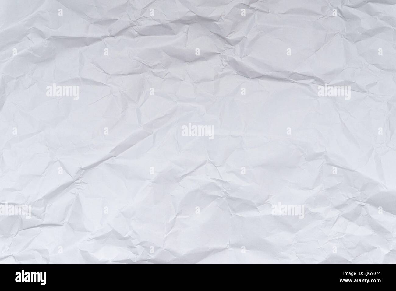 A mess of crumpled paper trash on a black background Stock Photo - Alamy