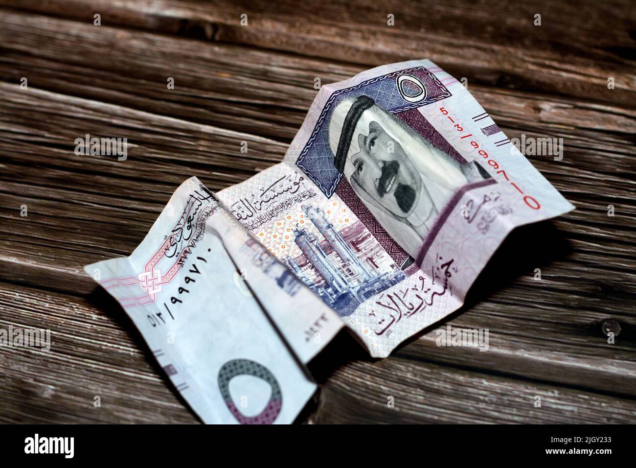 Crumpled Saudi Arabia money of 5 SAR five riyals isolated on wooden ...