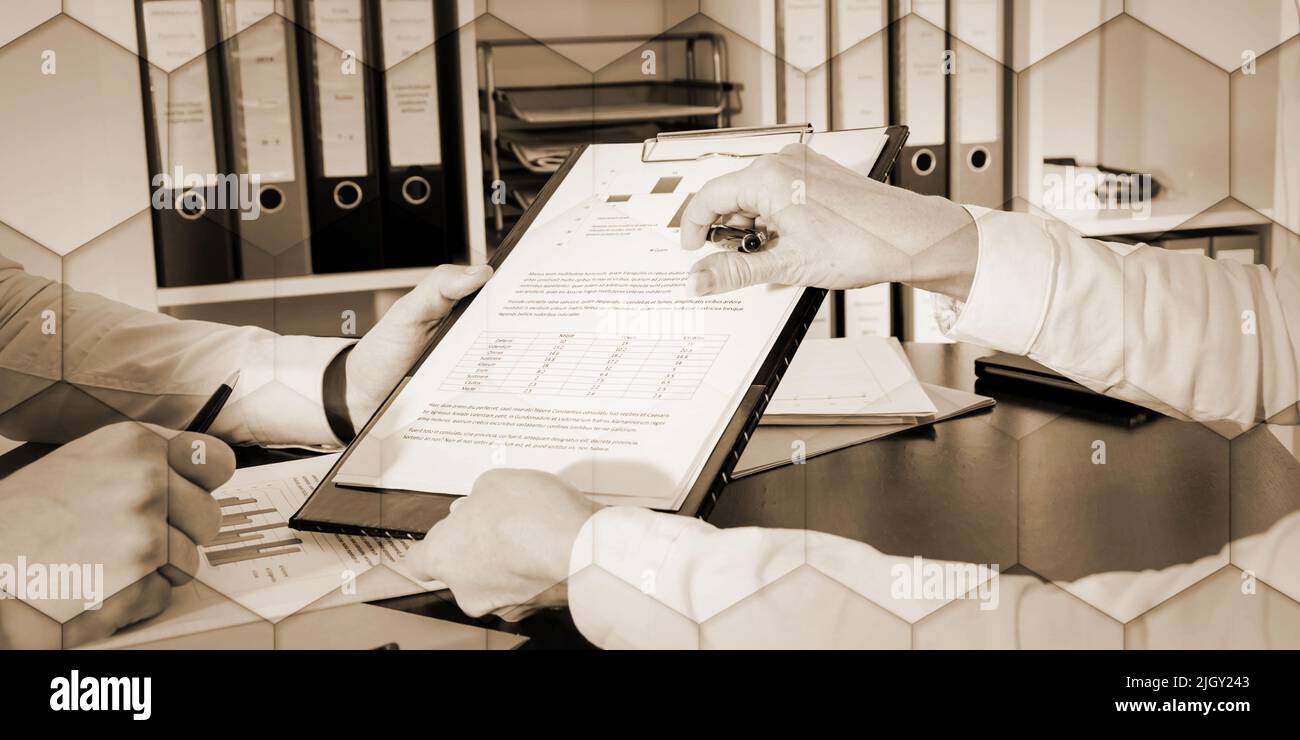 Two business people analyzing a chart, geometric pattern Stock Photo ...