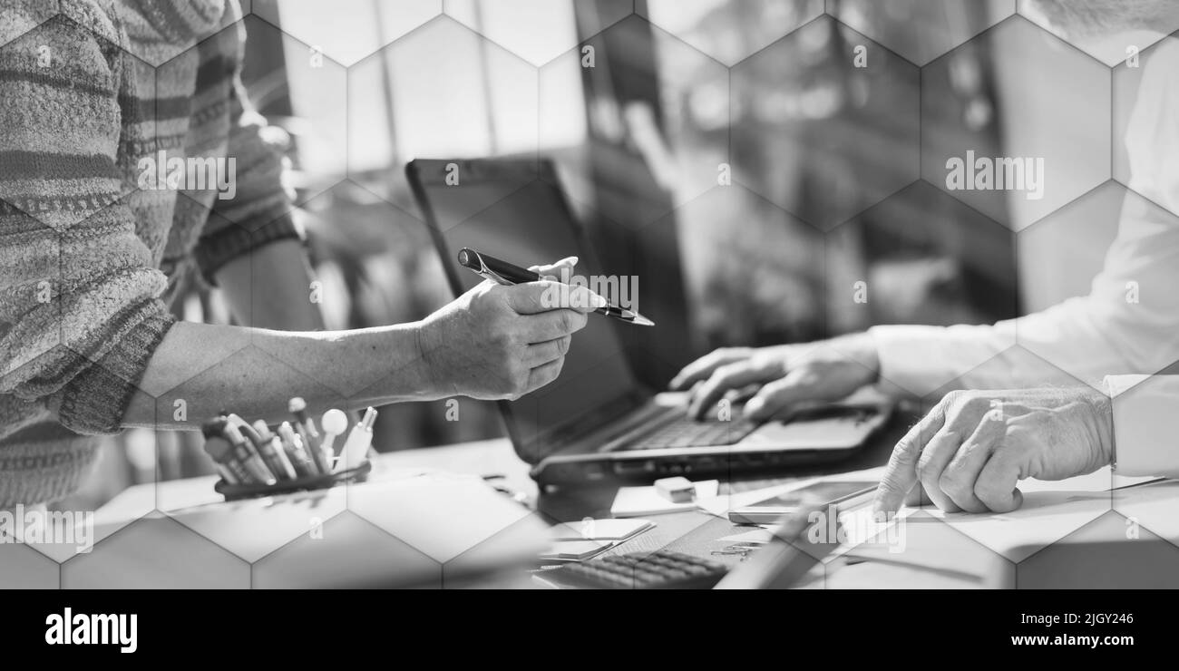 Manager working with executive assistant in office, geometric pattern ...