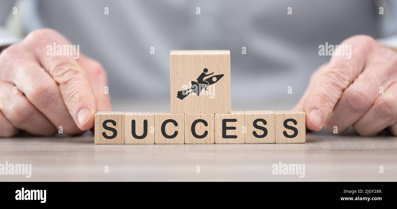 Wooden blocks with symbol of success concept Stock Photo - Alamy