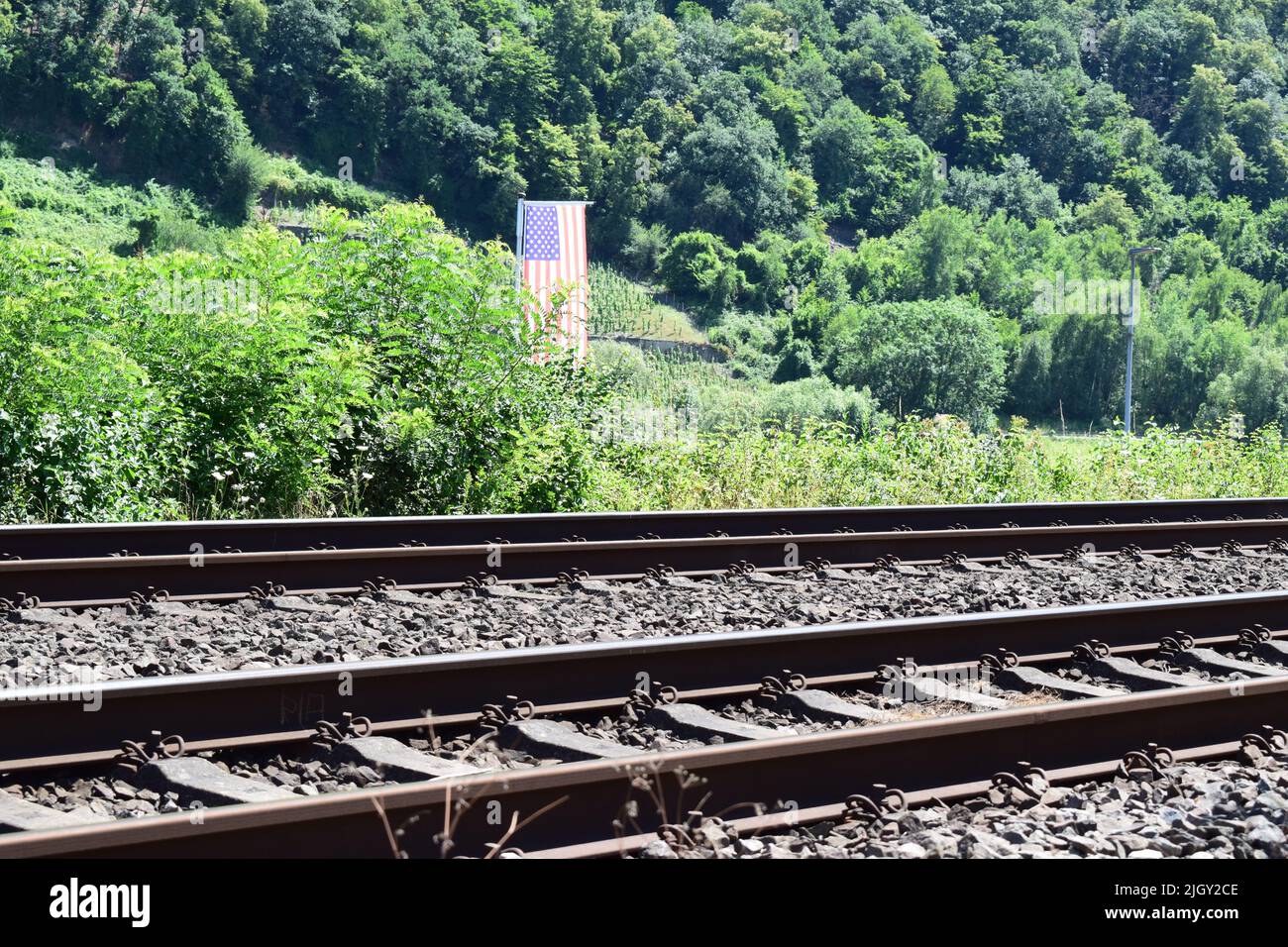 railroad tracks with an American flag Stock Photo - Alamy