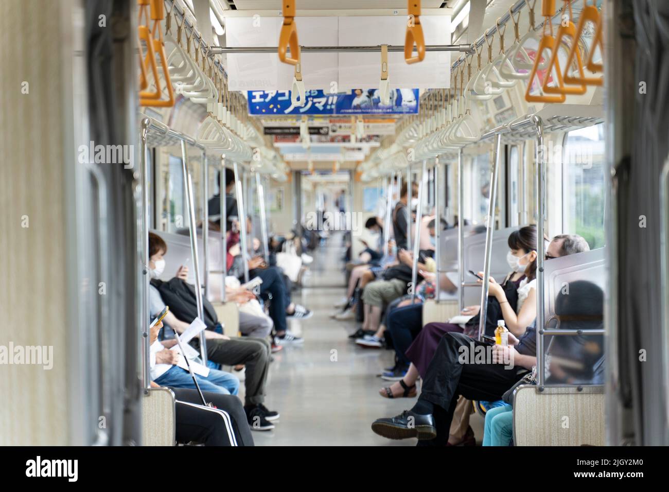 Tokyo, Japan- August 2, 2020: People sit in a train car in Tokyo Stock ...