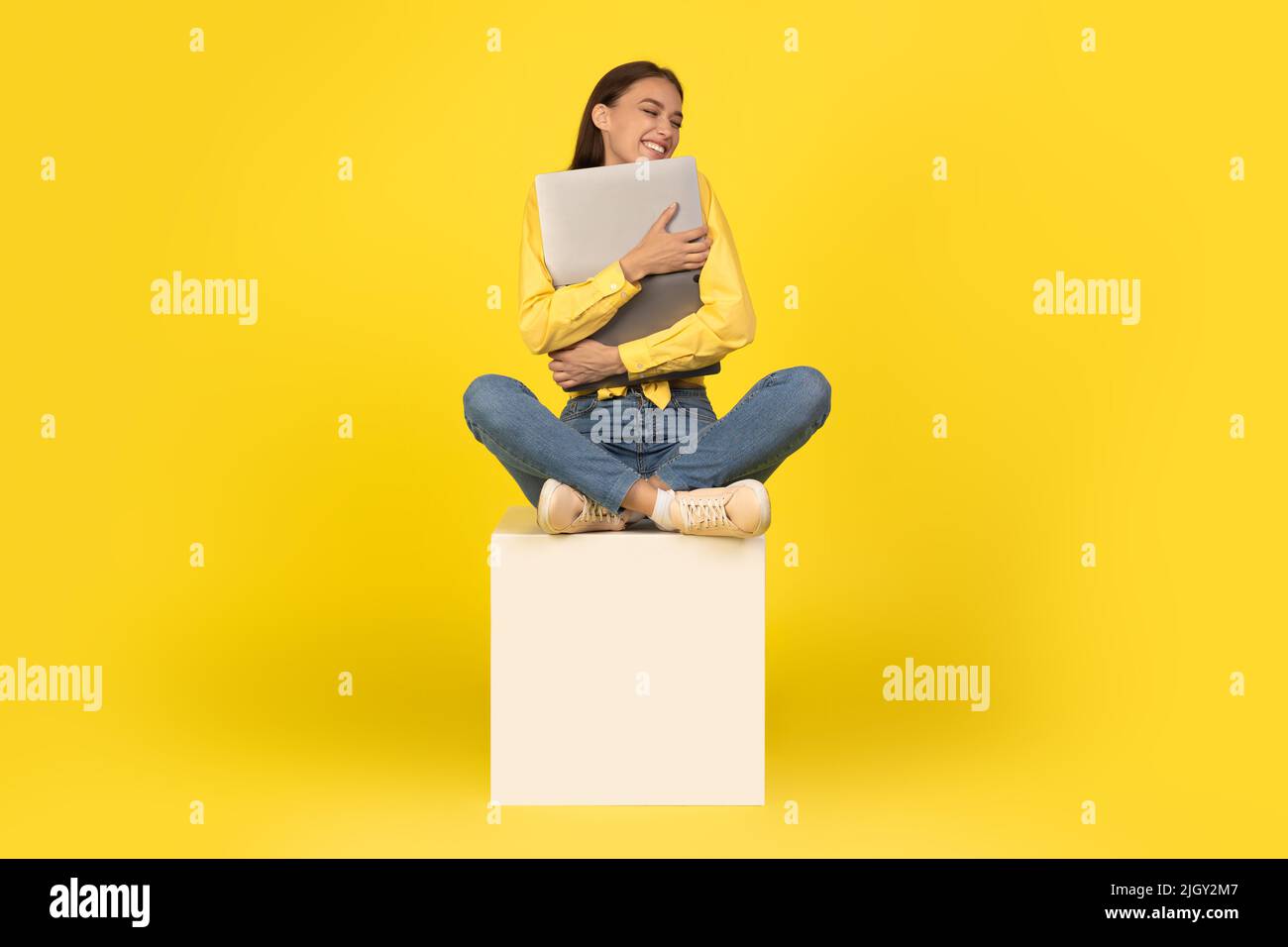 Happy Woman Hugging Laptop Computer Sitting Over Yellow Background ...