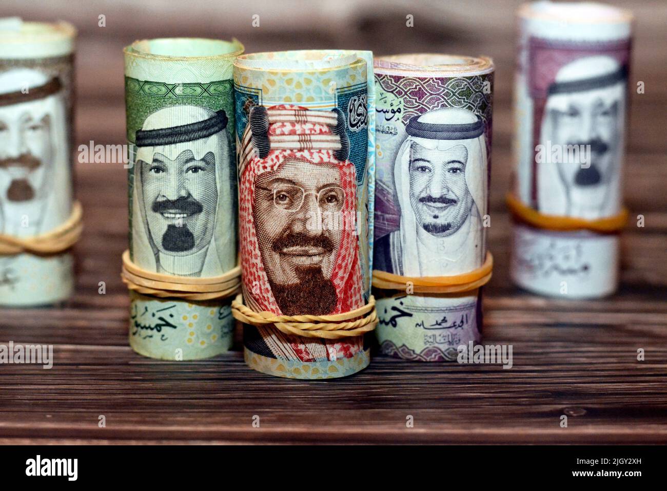Saudi Arabia money roll riyals banknotes isolated on wooden background ...