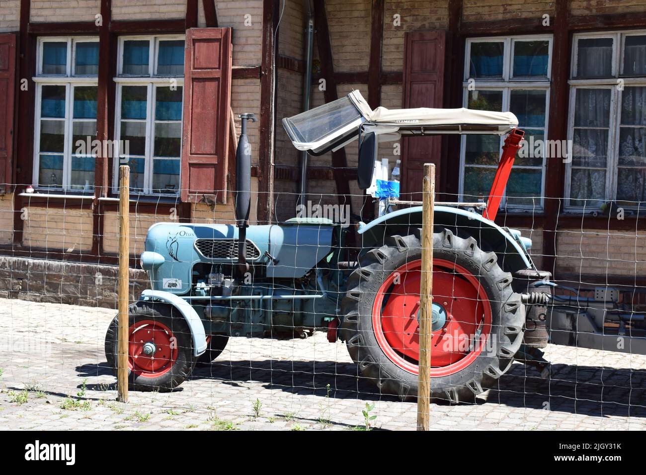 ancient tractor behind a fence Stock Photo - Alamy