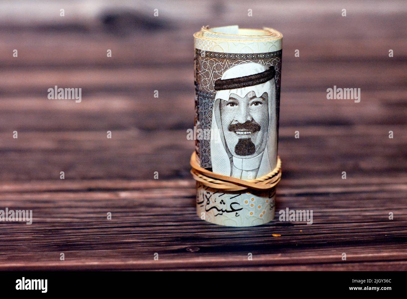 10 SAR ten Saudi riyals cash money banknote bills rolled up with rubber ...