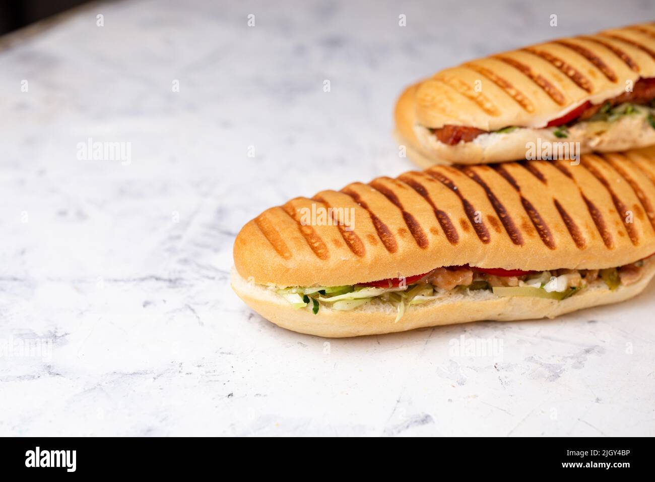 panini with filling. three panini on a white background Stock Photo - Alamy