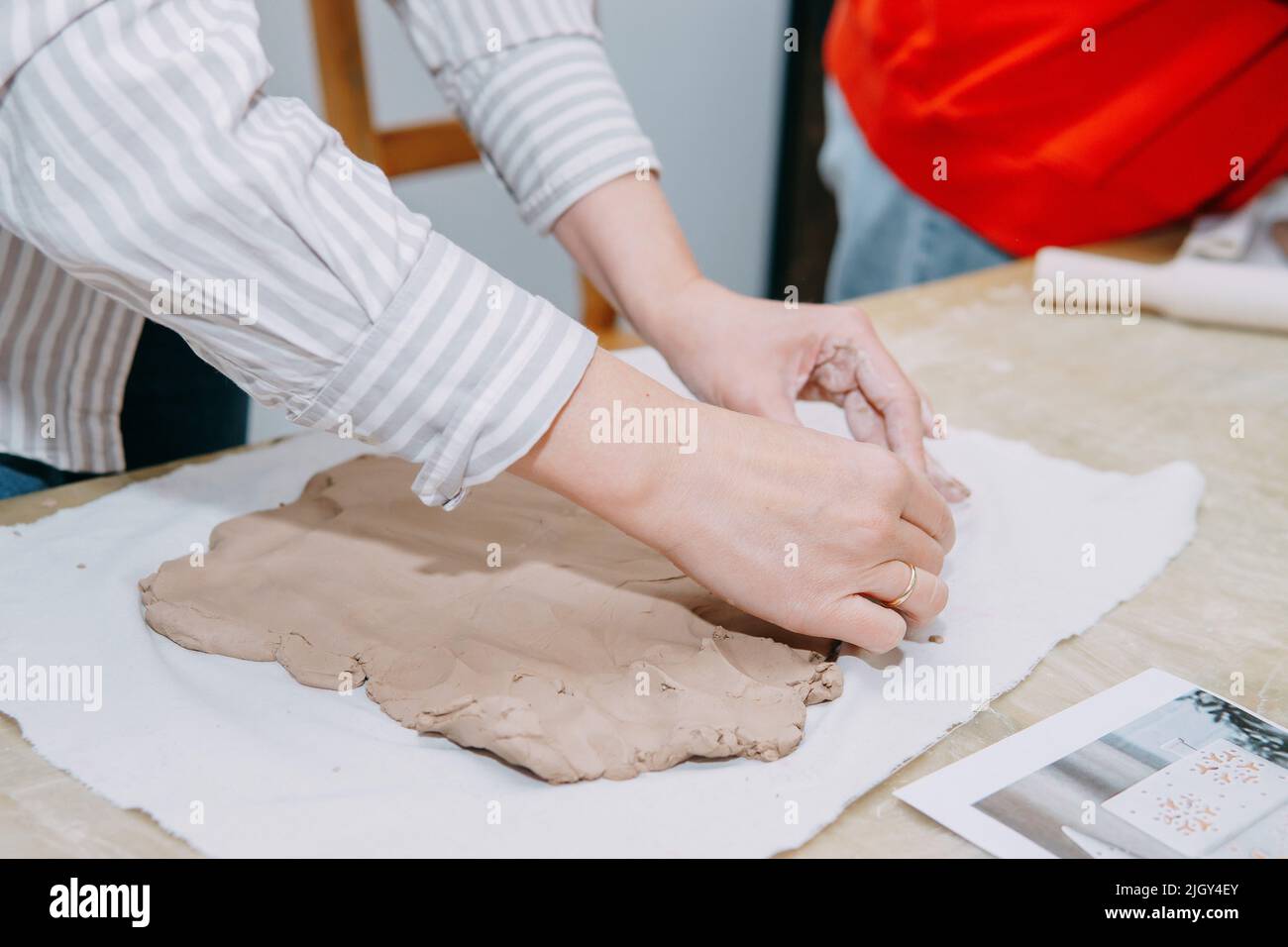 Female hands kneading clay. Production of ceramic products at the ...