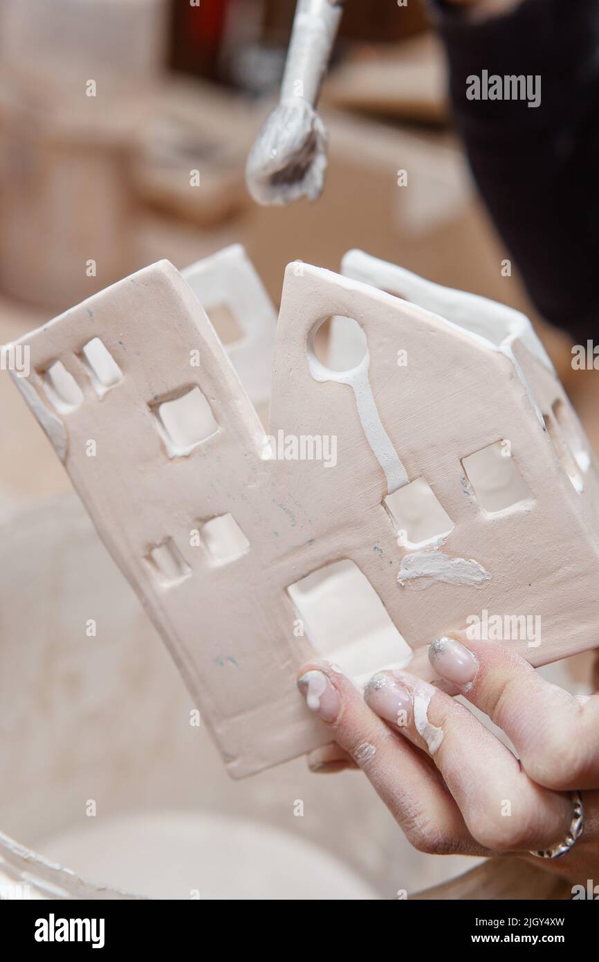 A master ceramist holds a clay product in his hands. Making a ceramic ...